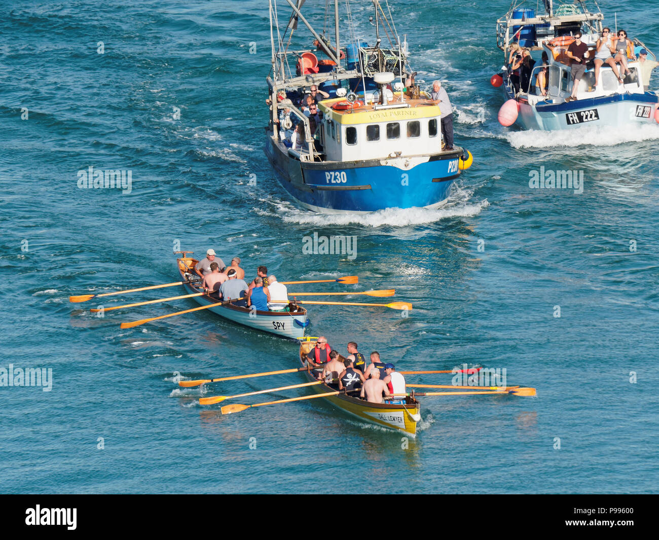 Fishing boats follow gig rowers hi-res stock photography and images - Alamy
