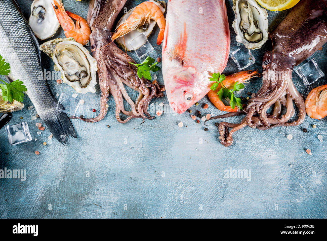 Fresh raw seafood squid shrimp oyster mussels fish with spices of herbs ...