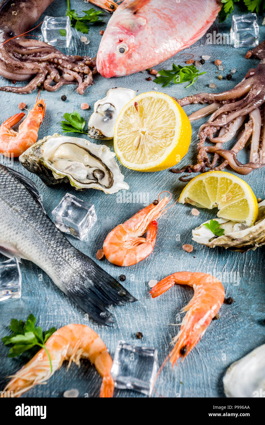 Fresh raw seafood squid shrimp oyster mussels fish with spices of herbs ...