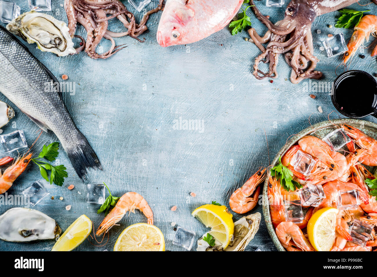 Fresh raw seafood squid shrimp oyster mussels fish with spices of herbs ...