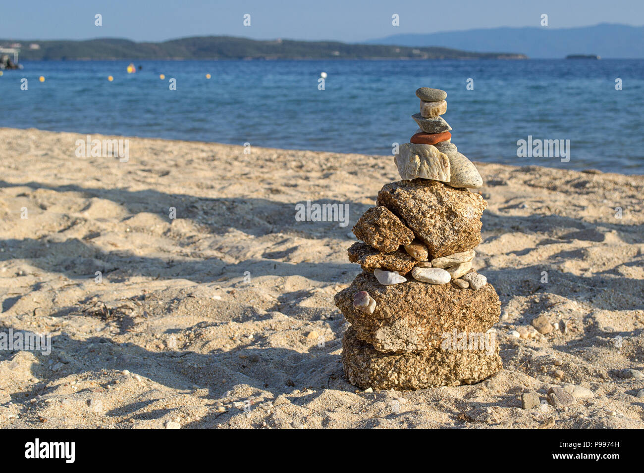 Stones balance on beach shot at sunset Stock Photo - Alamy