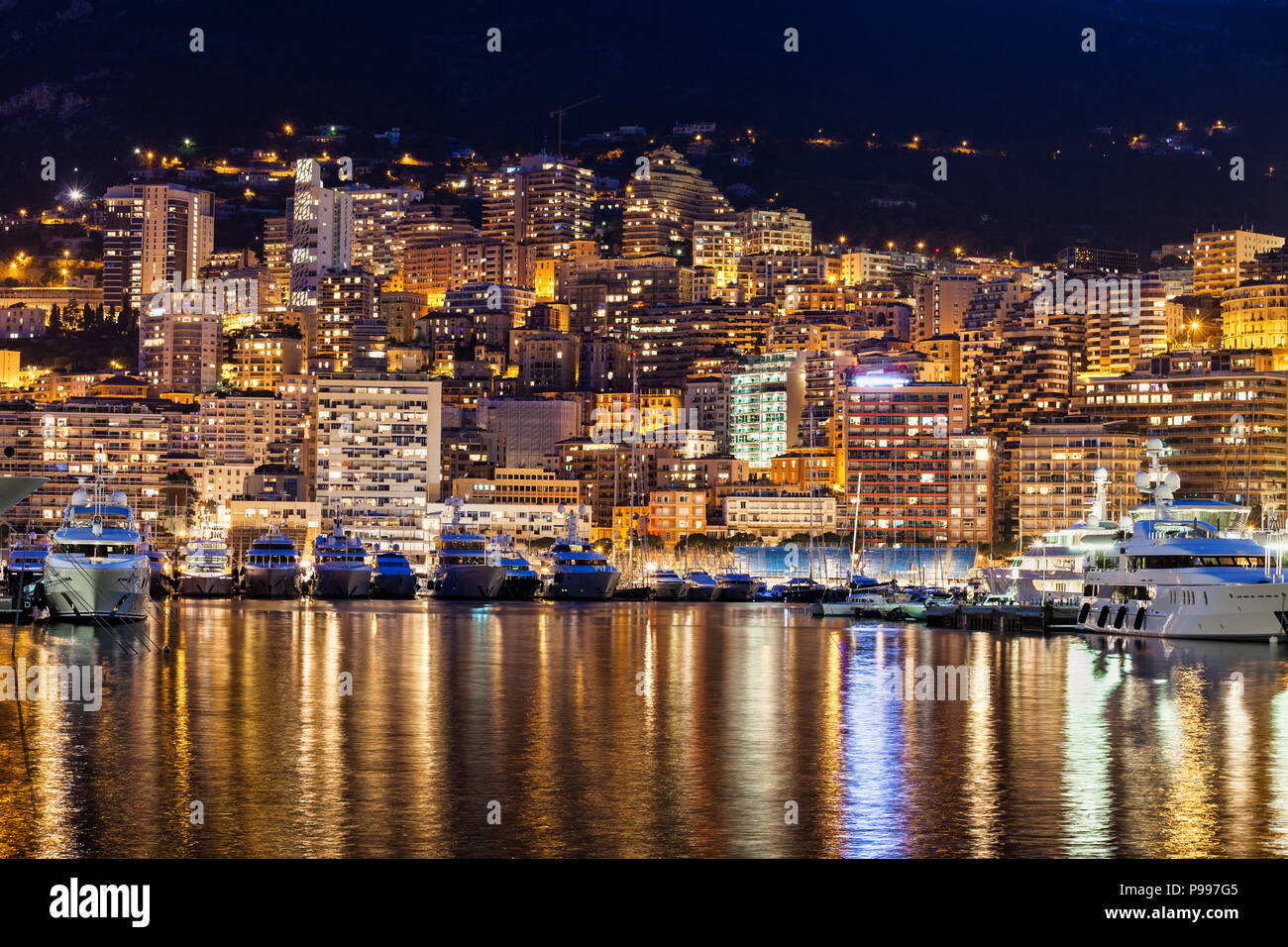 Monaco principality, city lights at night, modern apartment buildings ...