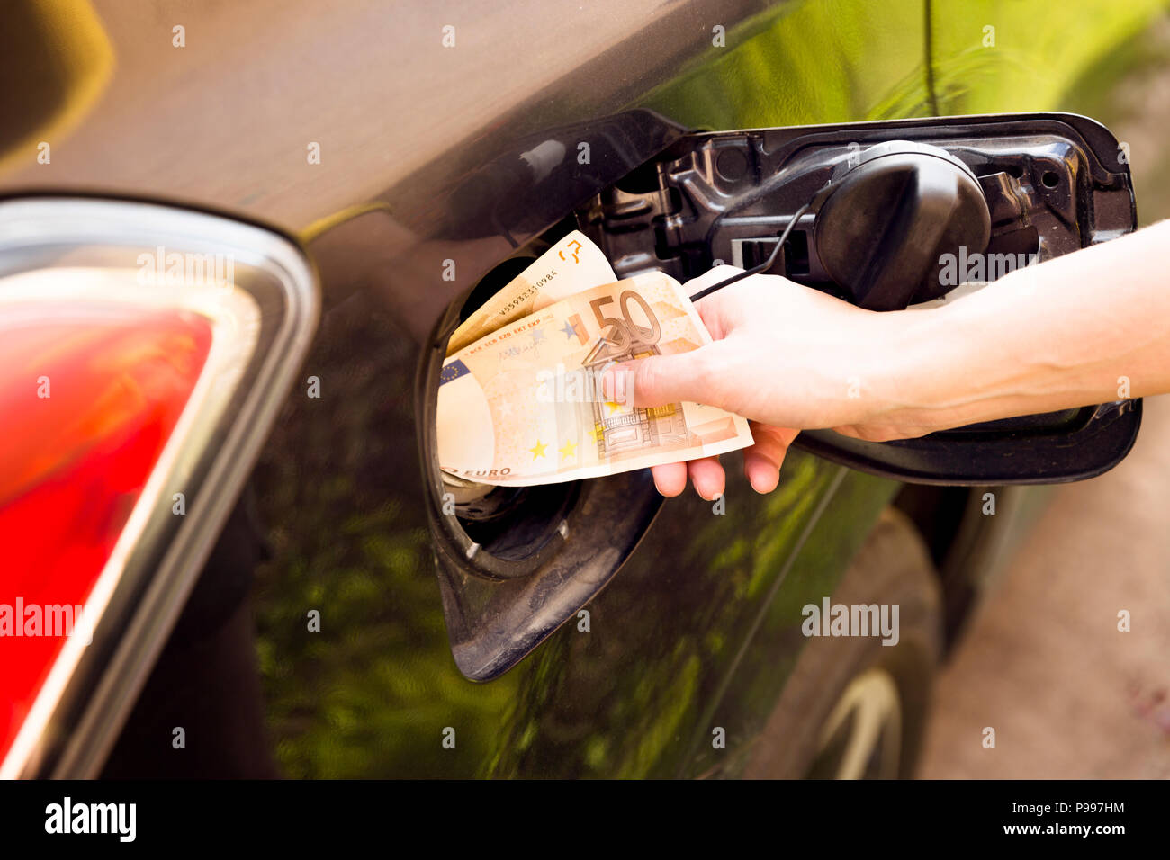 Transportation expenses concept - Euro money in car fuel tank Stock ...