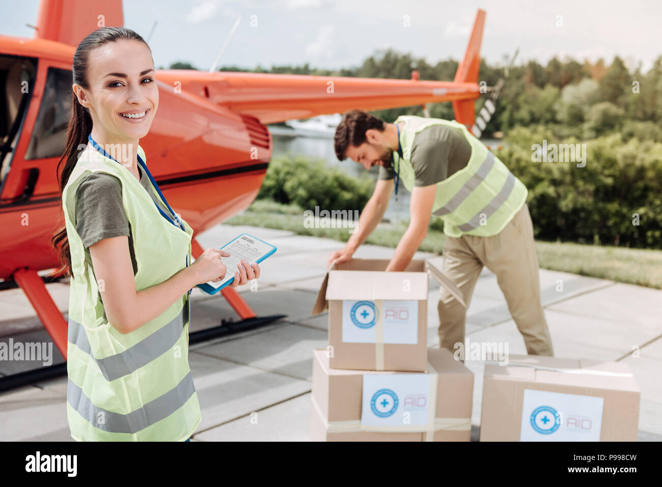 Ambitious two volunteers inspecting boxes Stock Photo - Alamy