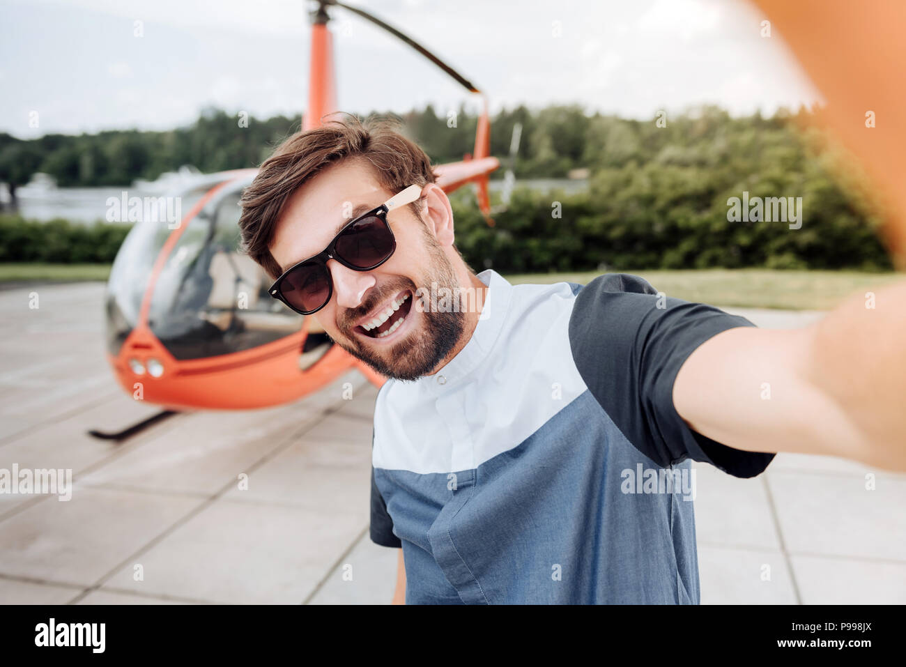 Jolly positive man having fun Stock Photo - Alamy