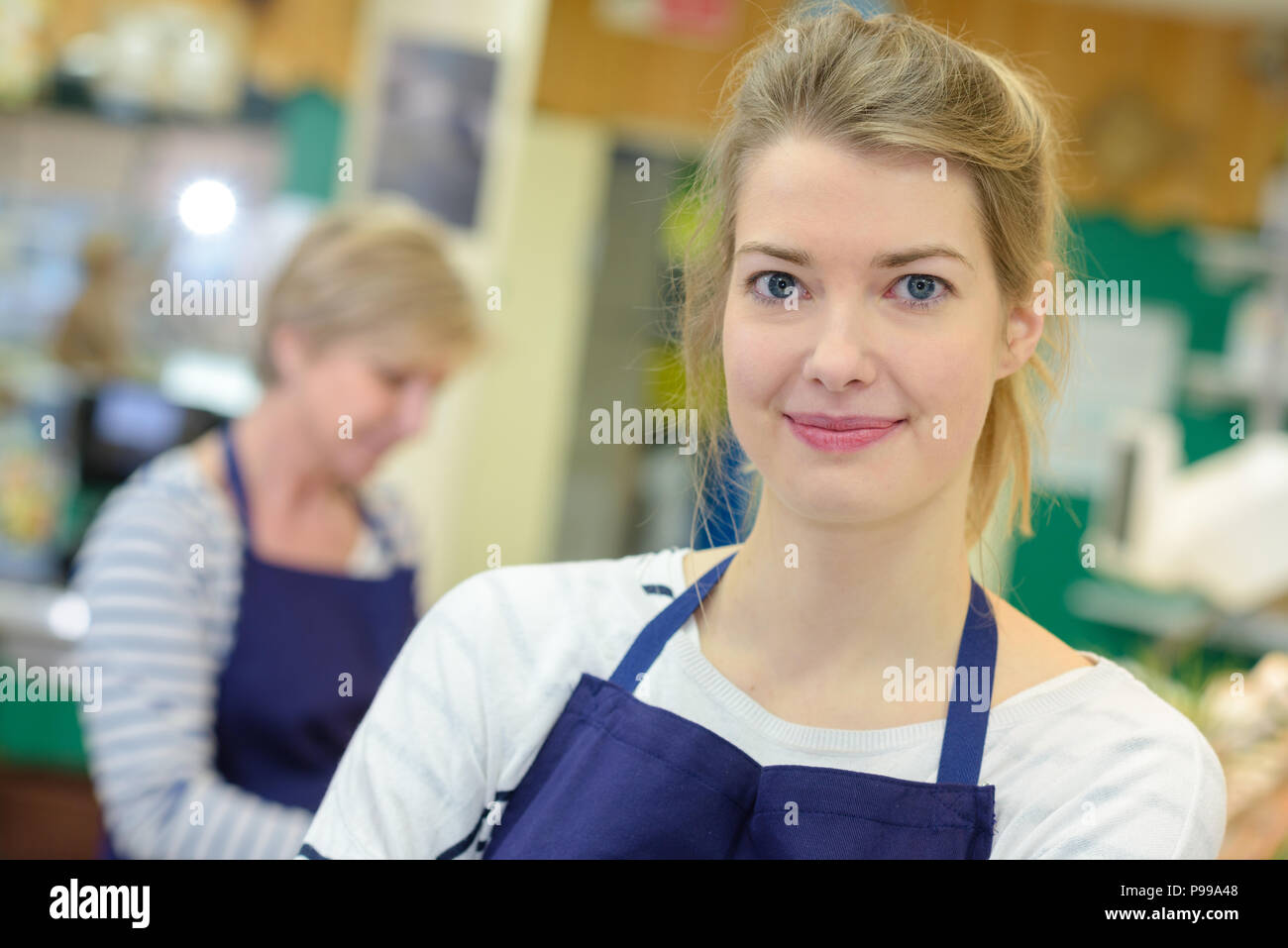 beautiful happy young woman in apron Stock Photo - Alamy