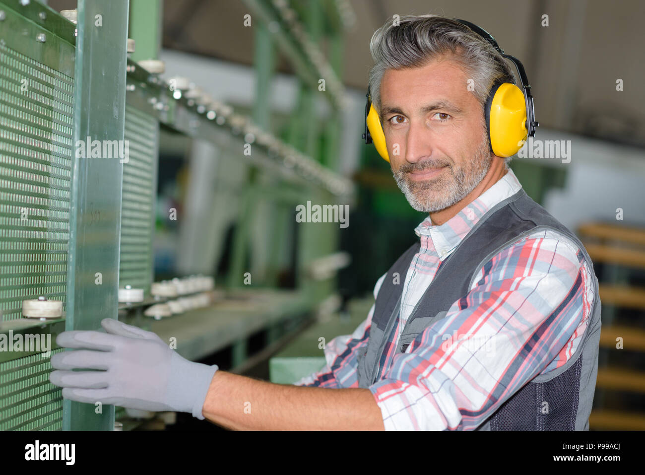 worker wearing hearing protection at a factory Stock Photo - Alamy