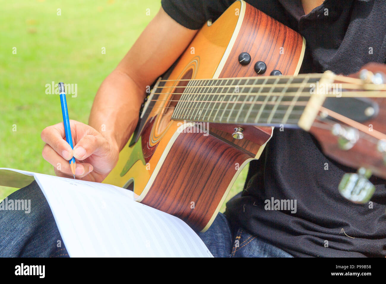composer write note of song and use acoustic guitar for play Stock ...