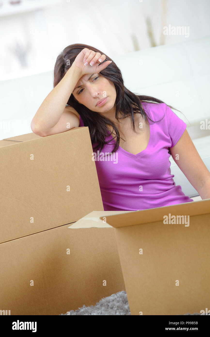 Sad woman packing boxes hi-res stock photography and images - Alamy