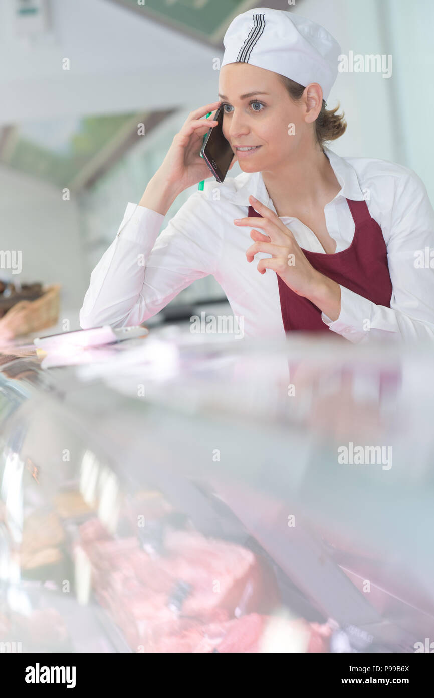 Female butcher on telephone Stock Photo - Alamy