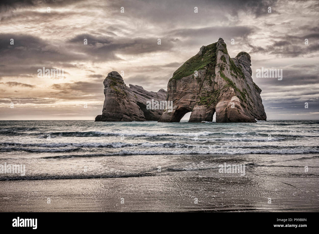 The Archway Islands off Wharariki Beach at the northern tip of New Zealand's South Island Stock ...