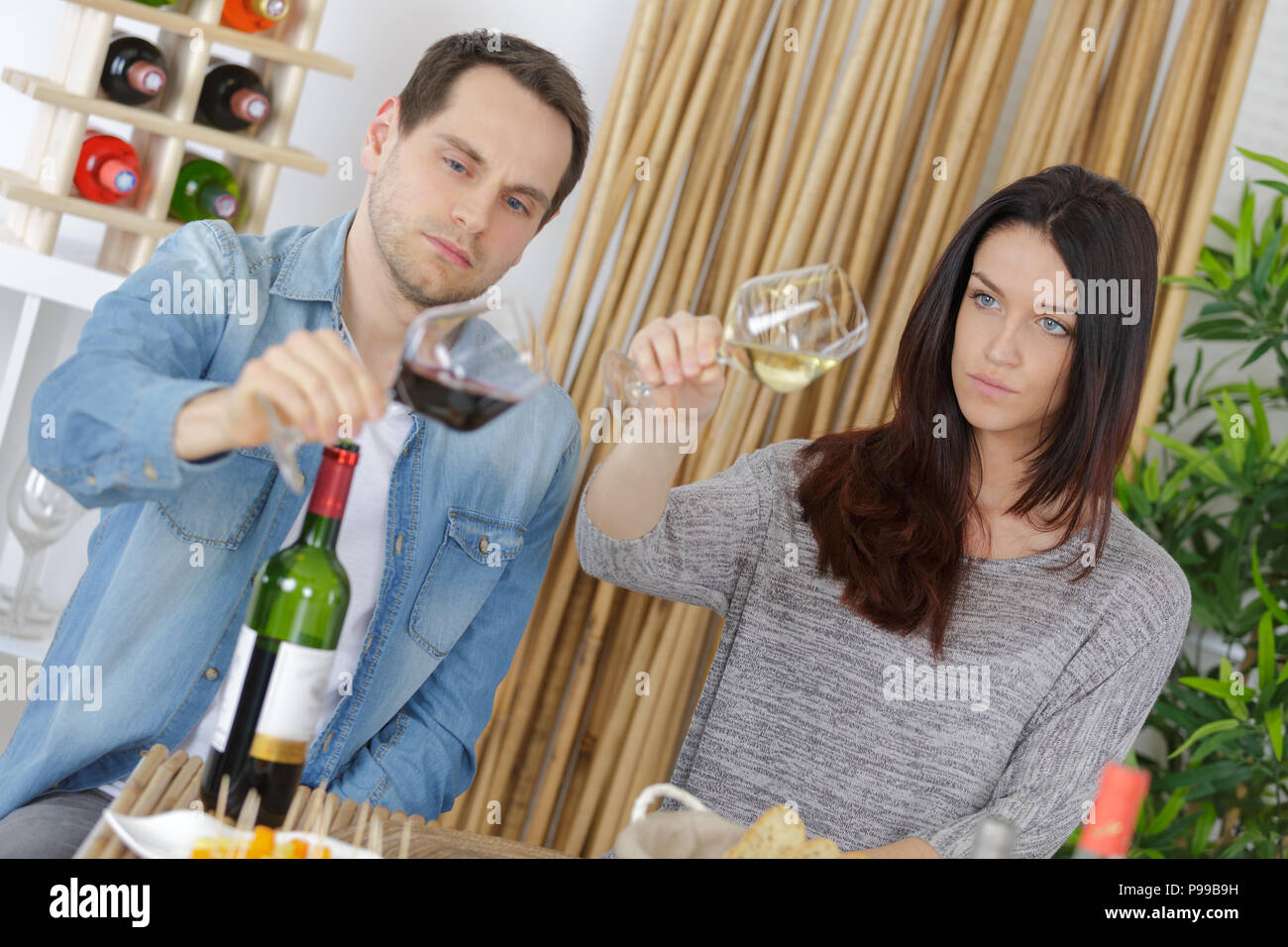 wine loving couple tasting wines in winery cellar Stock Photo - Alamy