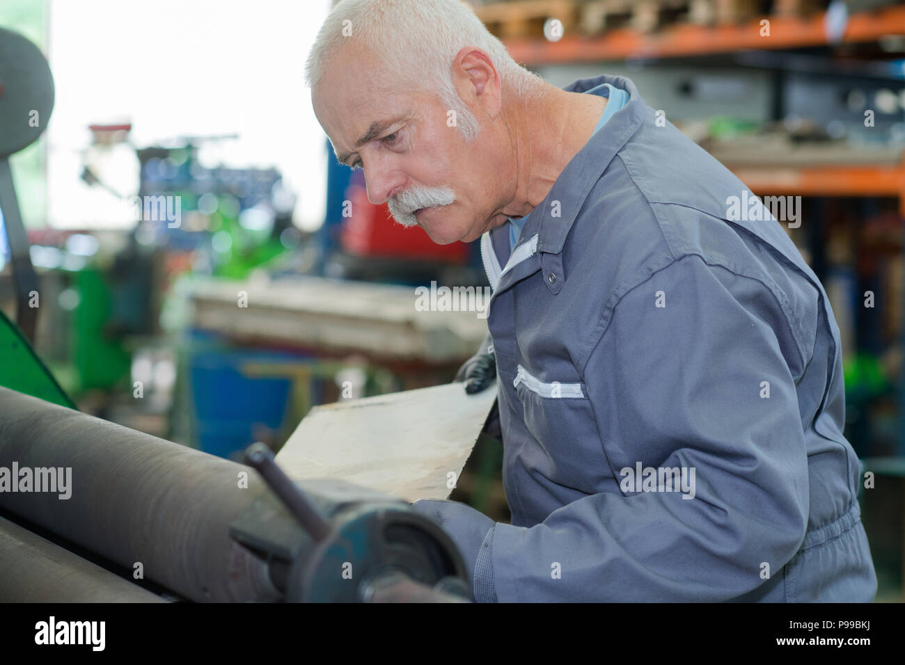 old mechanic working in a factory Stock Photo - Alamy