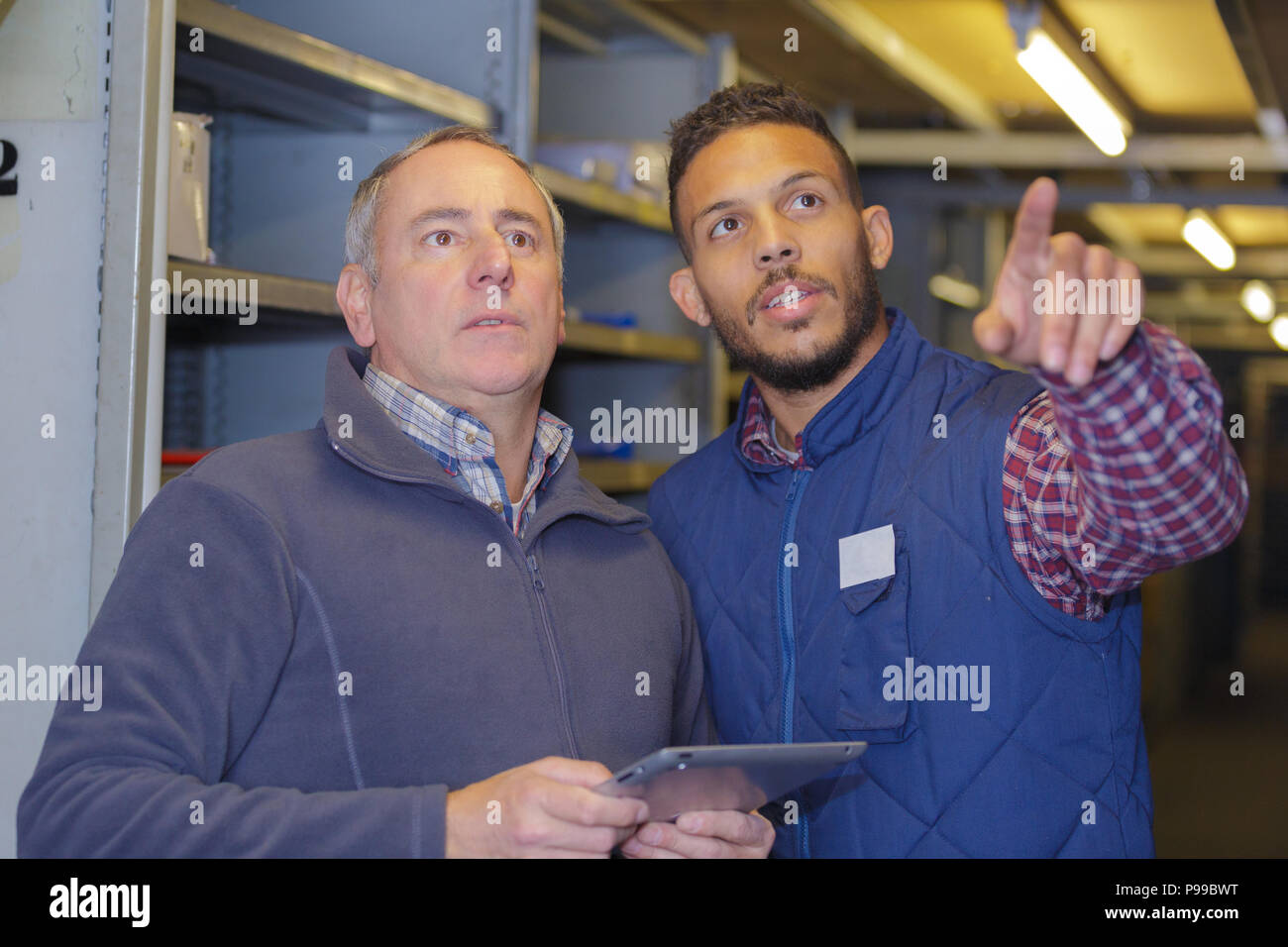 two workers solving a problel Stock Photo - Alamy