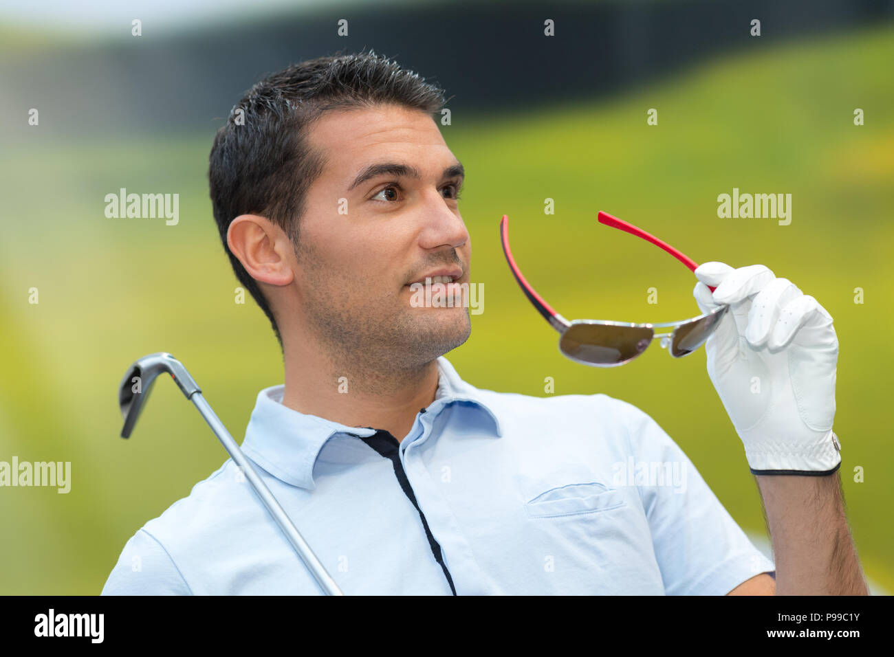 athletic young man playing golf Stock Photo - Alamy