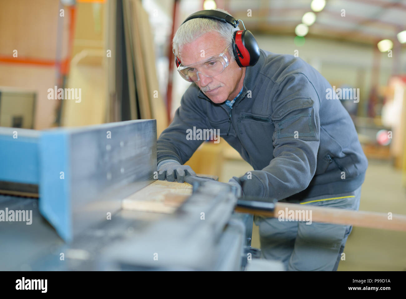Man using woodworking machine Stock Photo - Alamy