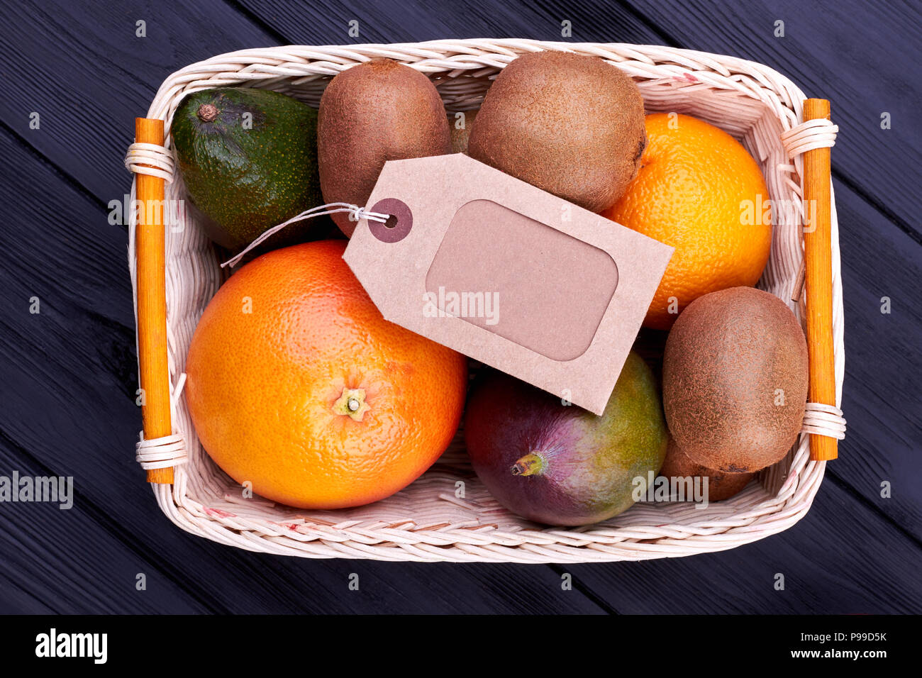 Assortment of fruits in basket and label. Assorted tropical fruits in ...