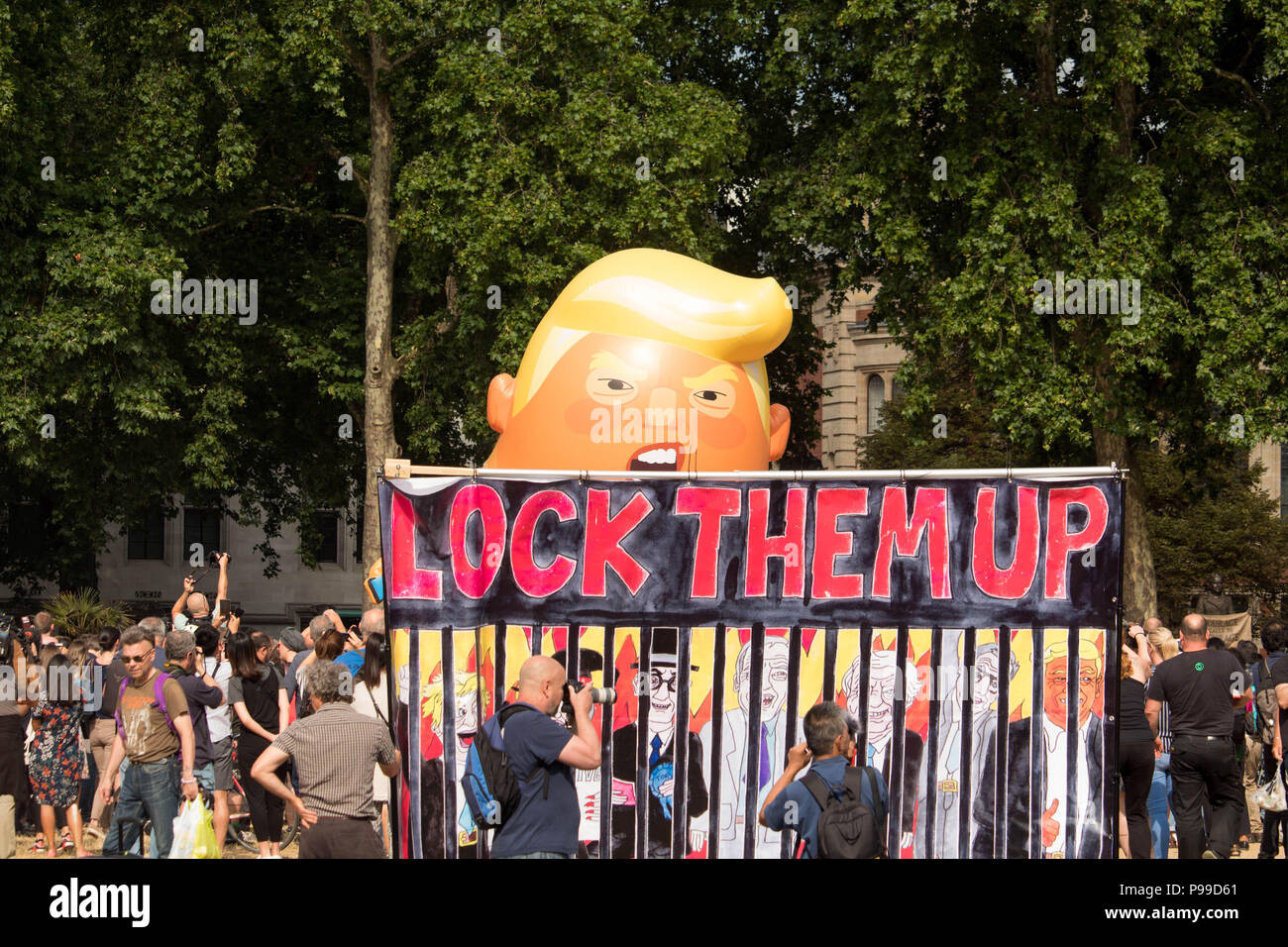 ‘Trump Baby’ giant inflatable resting above ' Lock Them Up' sign at ...