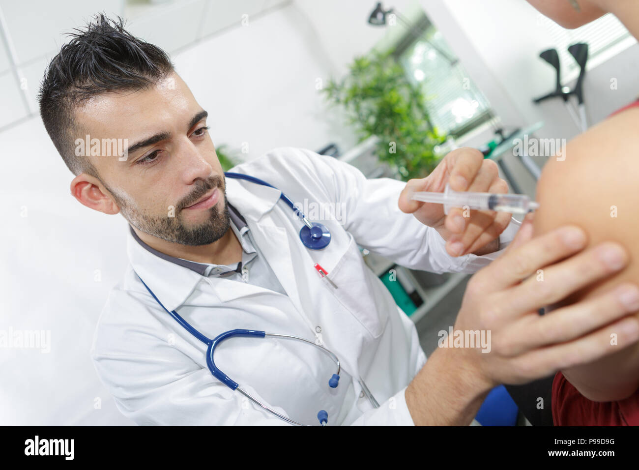 young doctor doing an injection Stock Photo - Alamy