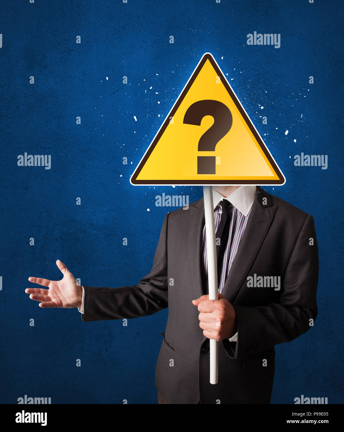 Smart businessman holding yellow sign with question mark Stock Photo ...