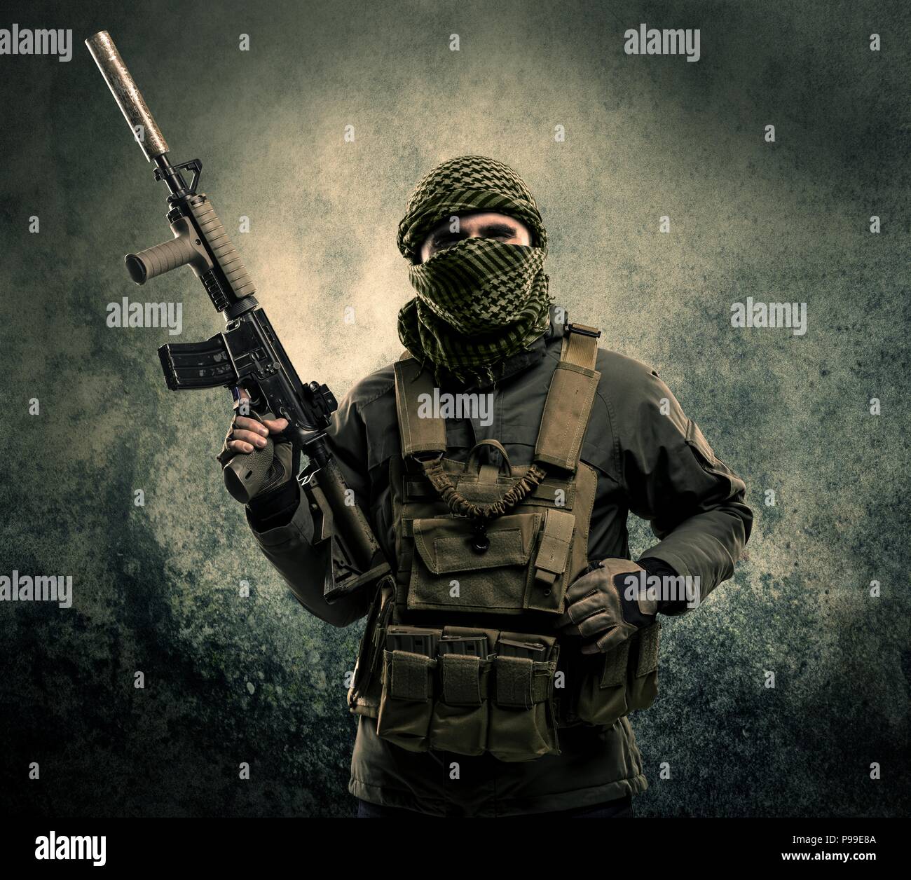 Portrait of a heavily armed masked soldier with grungy background ...