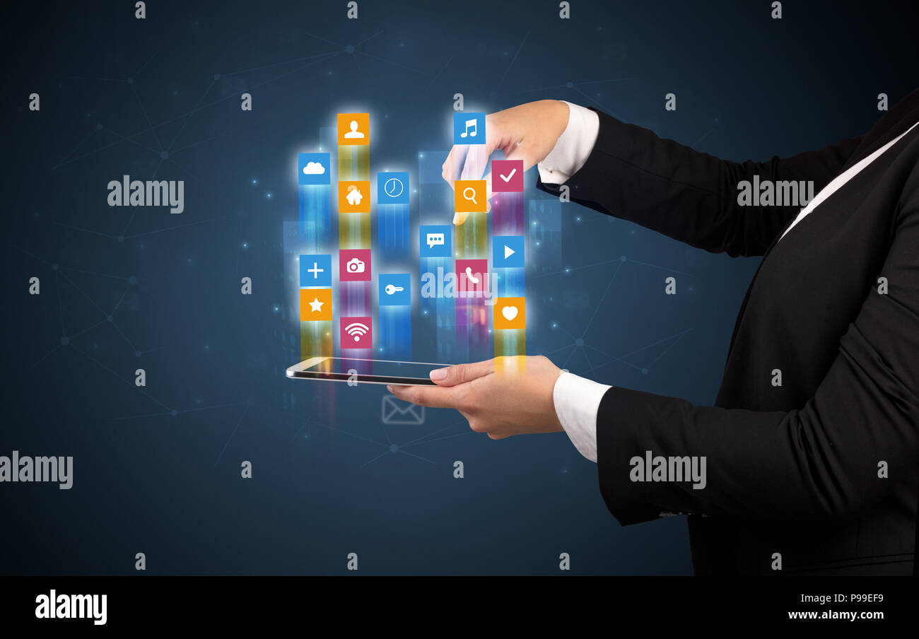 Female elegant hand holding tablet with colourful application icons ...
