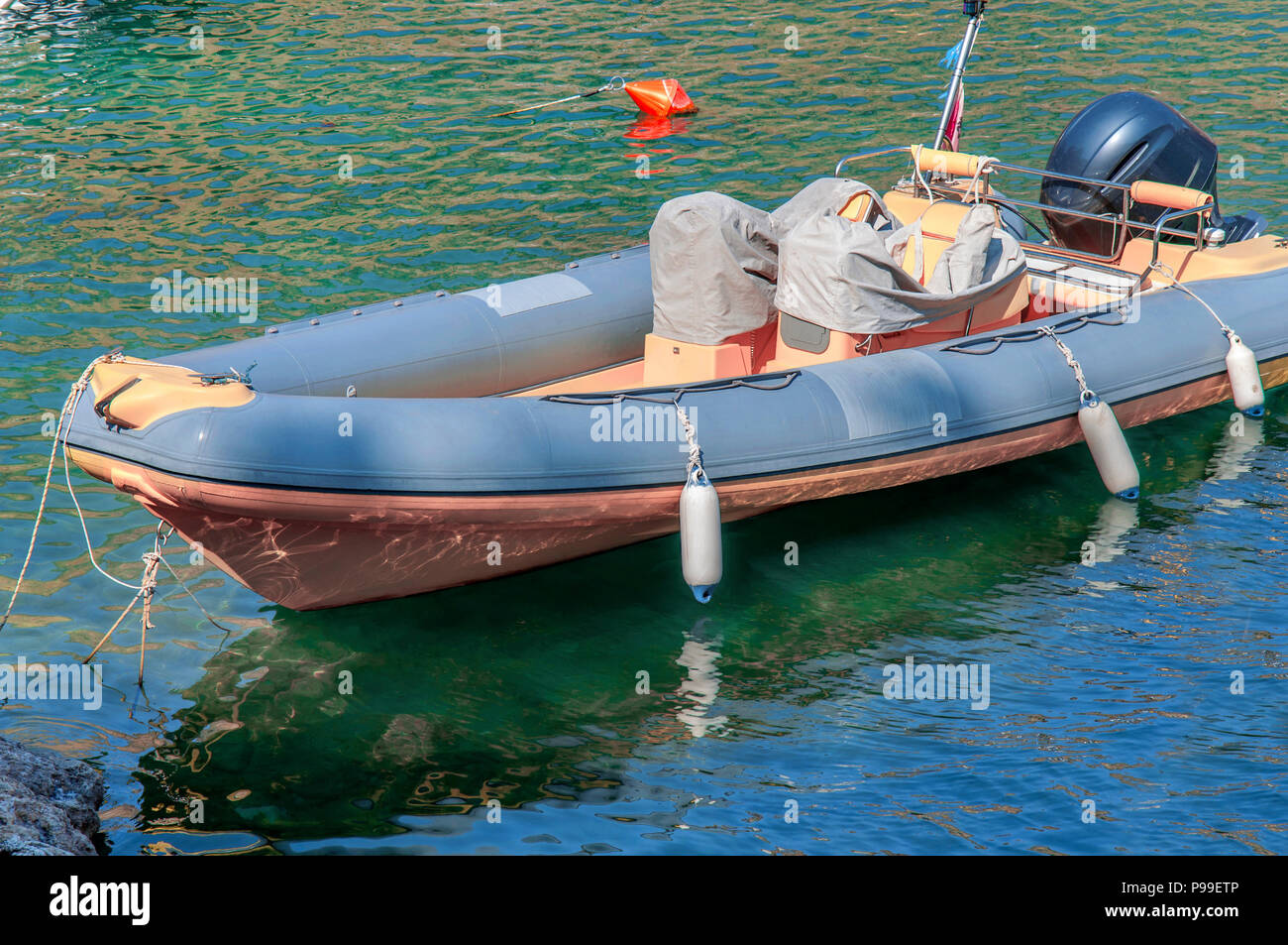 Gray and yellow docked vintage wooden motor boat at sea Stock Photo - Alamy