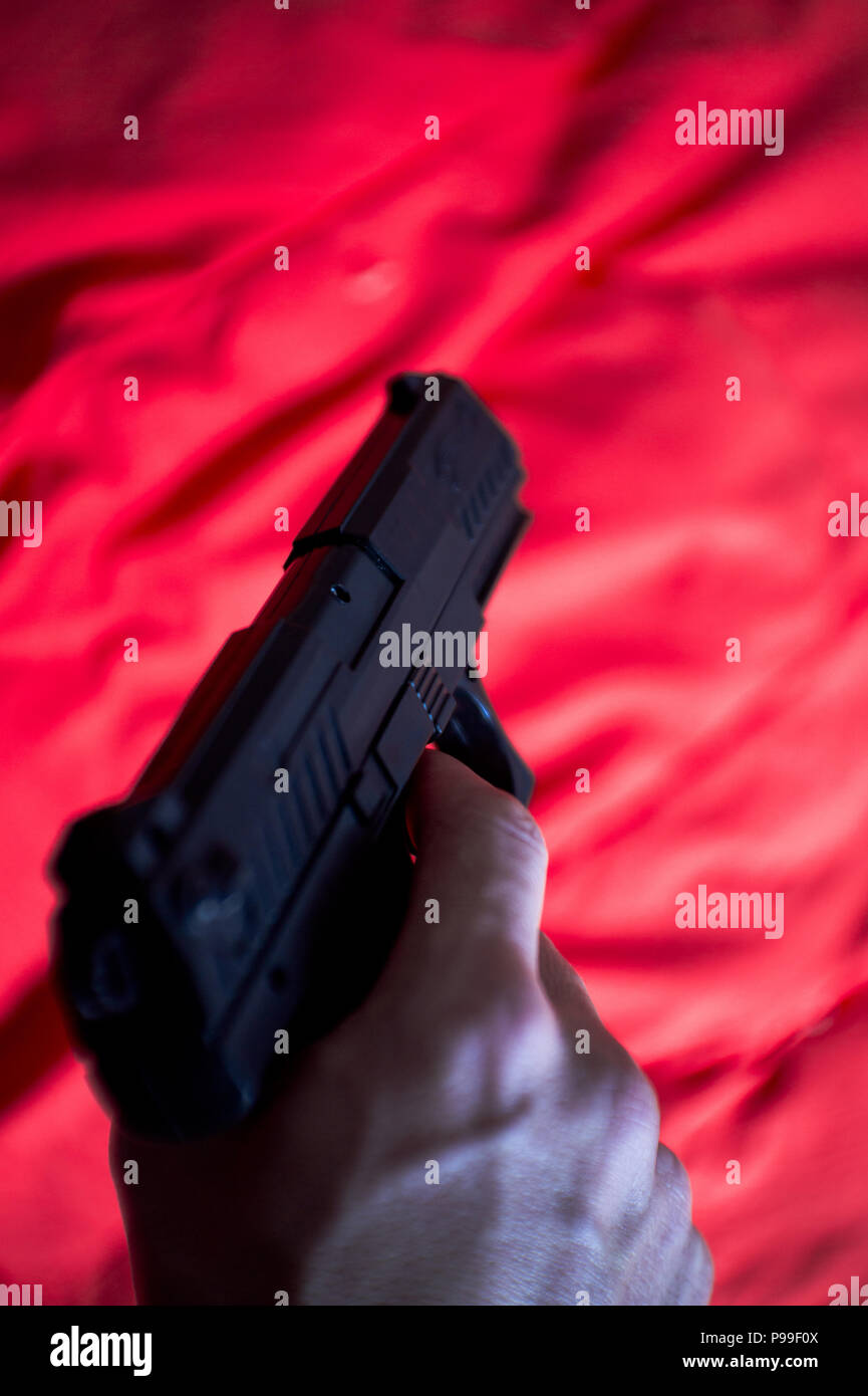 Gun held by a mans hand Stock Photo - Alamy