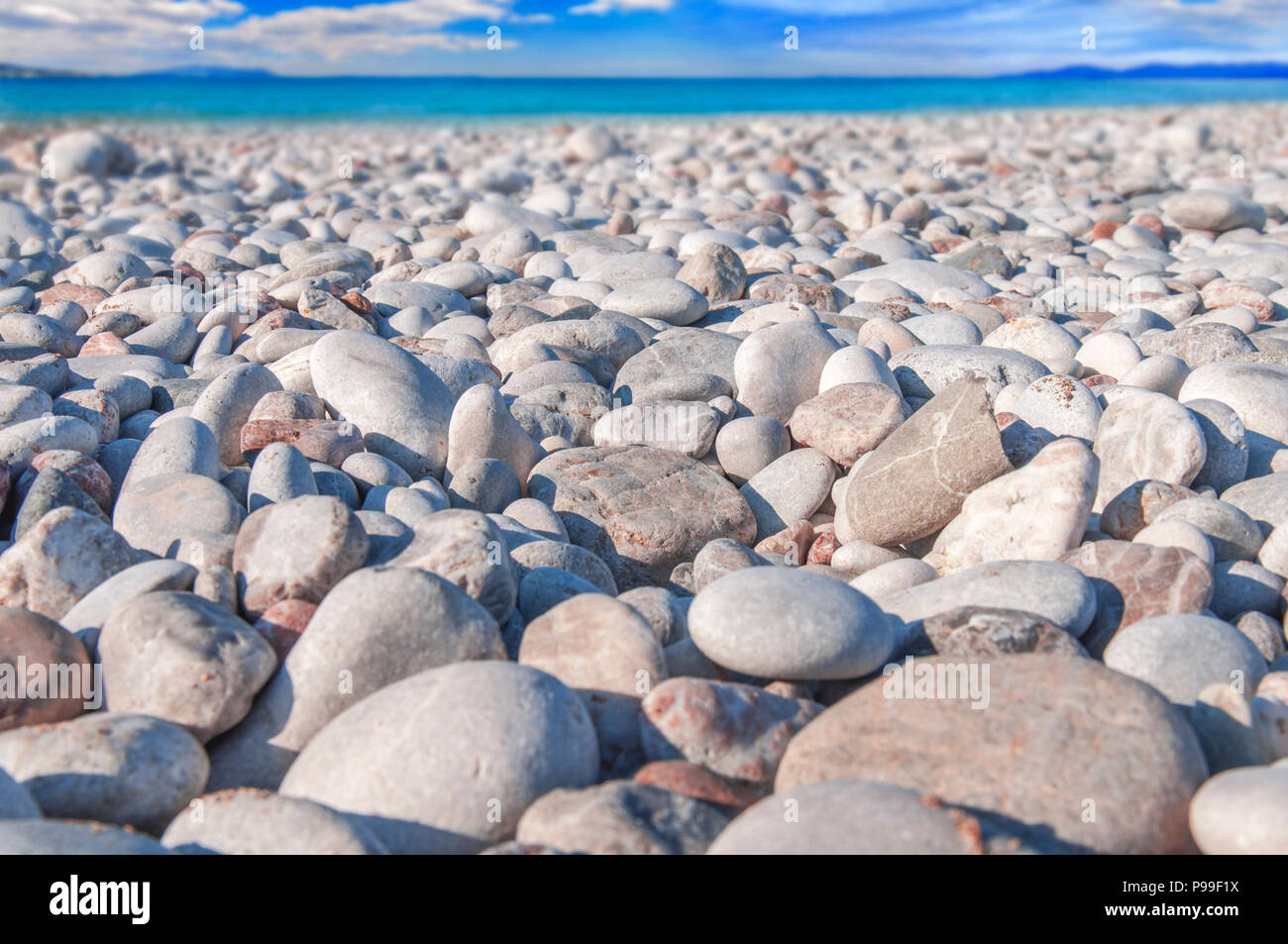 Close view of small and big pebble stone with sea background Stock ...