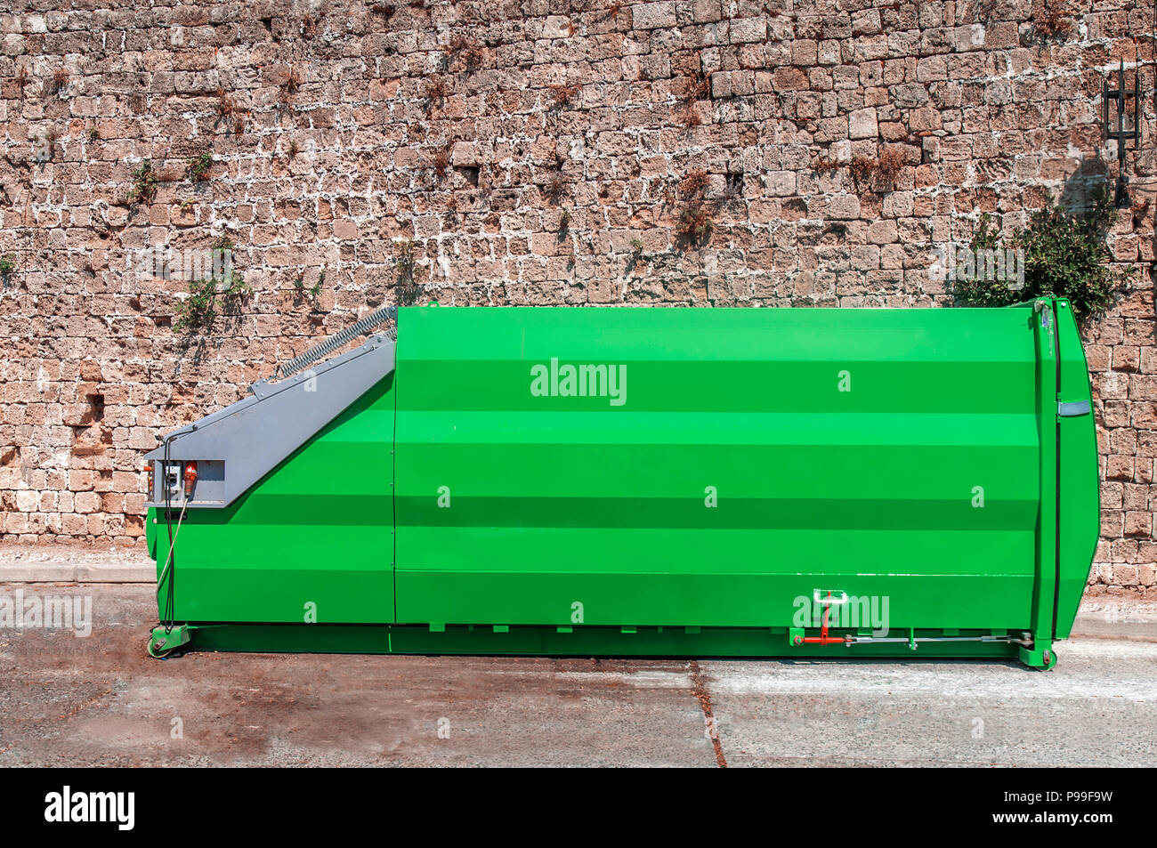 Green removable truck garbage trash container at street waiting for ...