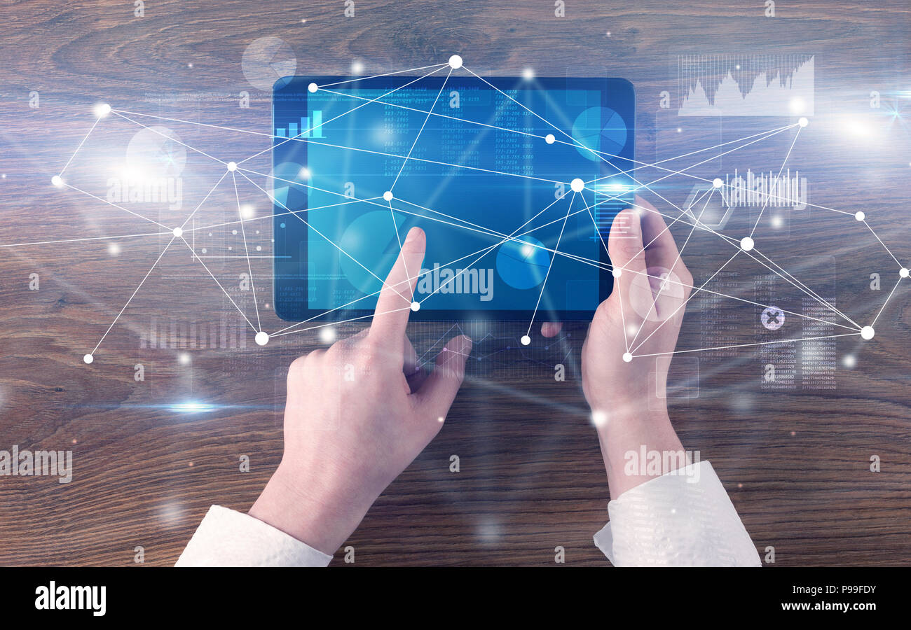 Hand using tablet with linking graphs charts report and informational ...