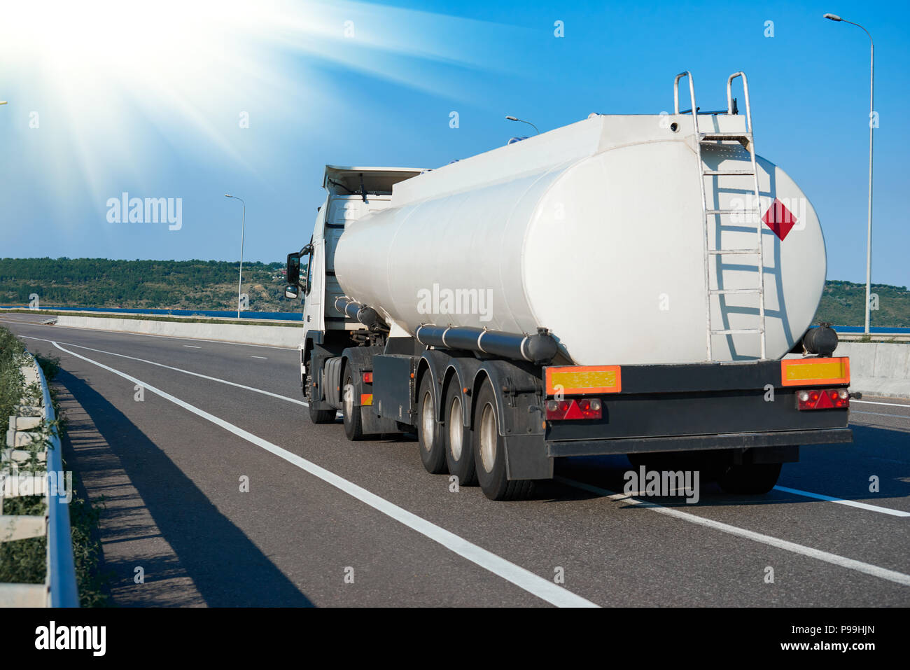 tank truck rides on highway, white blank color, rear view, one object ...