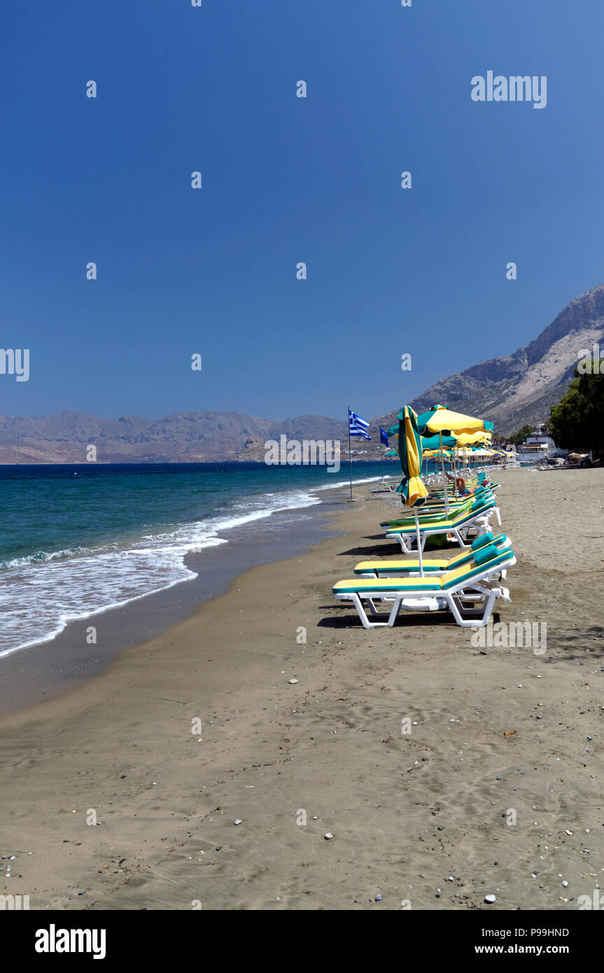 Bed chairs and sun shades, Masouri Beach, Kalymnos, Dodecanese islands ...