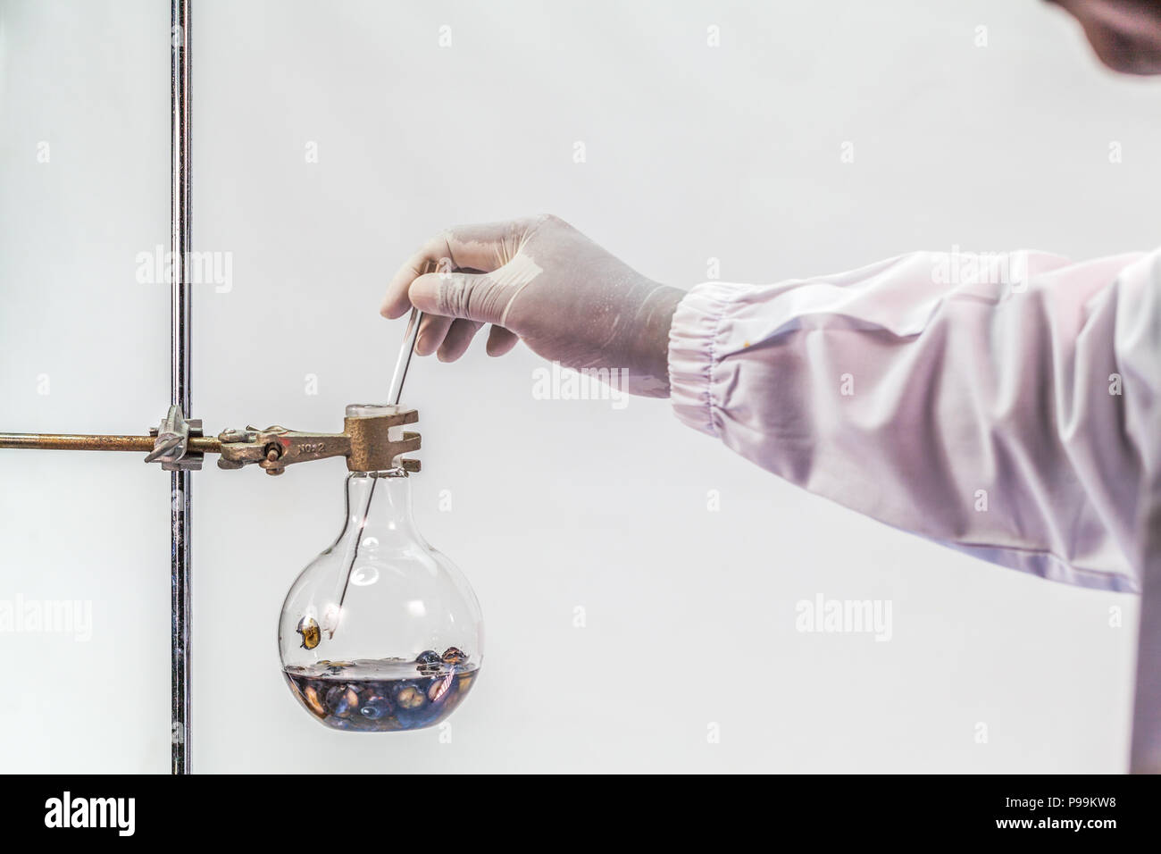 a scientist in Laboratory refining equipment Distillation of Alcohol ...