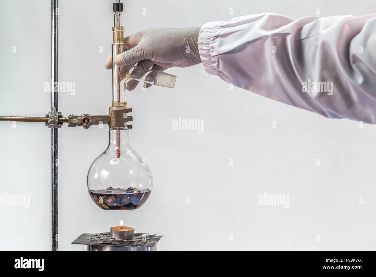 a scientist in Laboratory refining equipment Distillation of Alcohol ...