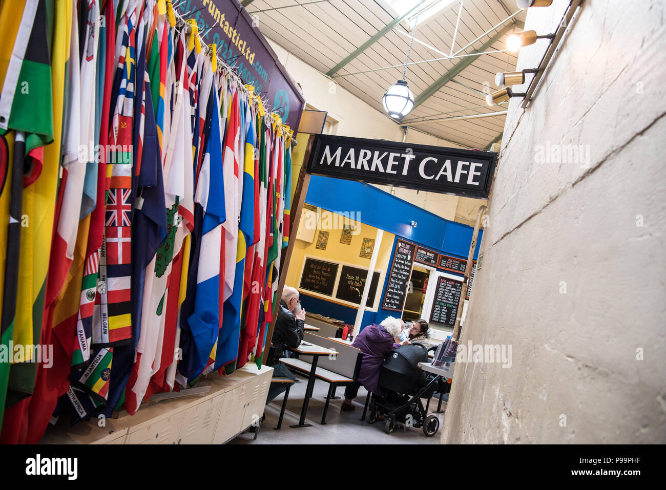 A wall full of international flags hanging from a stall at The ...