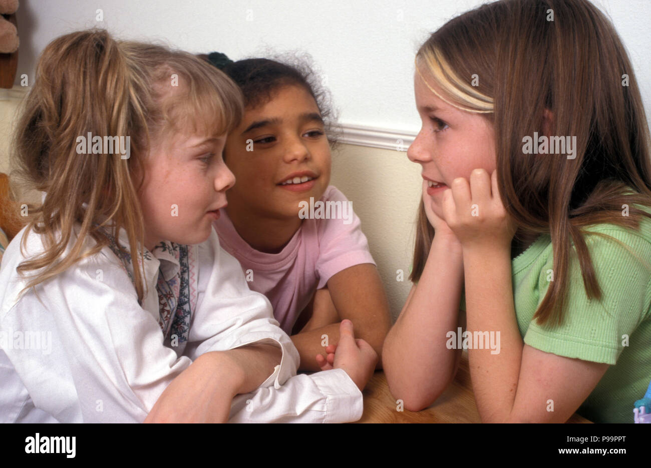 three young girls chatting Stock Photo - Alamy