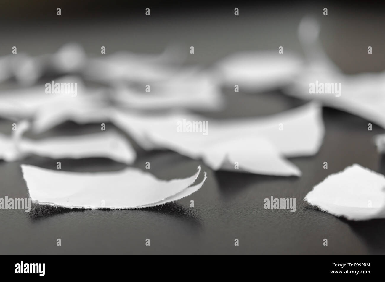 Paper ripped in many pieces with blurry background Stock Photo - Alamy