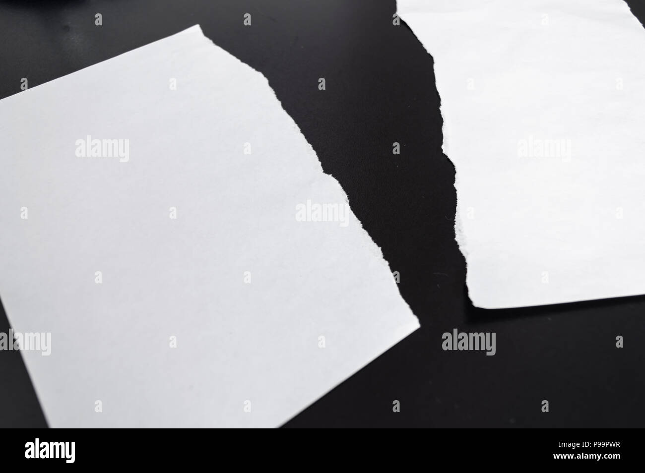Papper torn in two pieces Stock Photo - Alamy