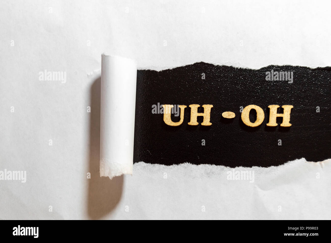 Ripped paper with text below it Stock Photo - Alamy