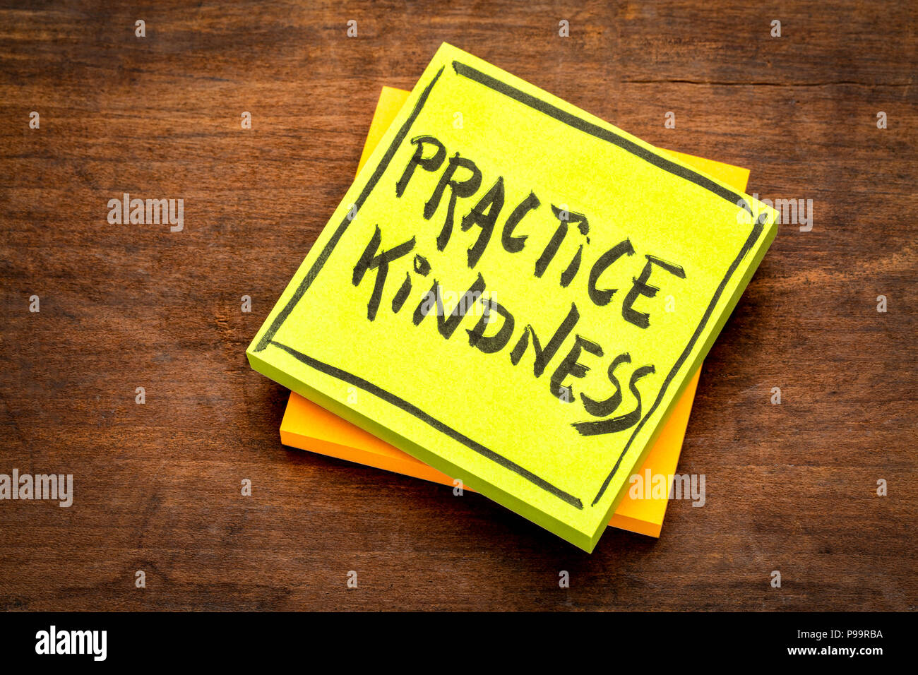Practice kindness reminder - handwriting on a sticky note against ...