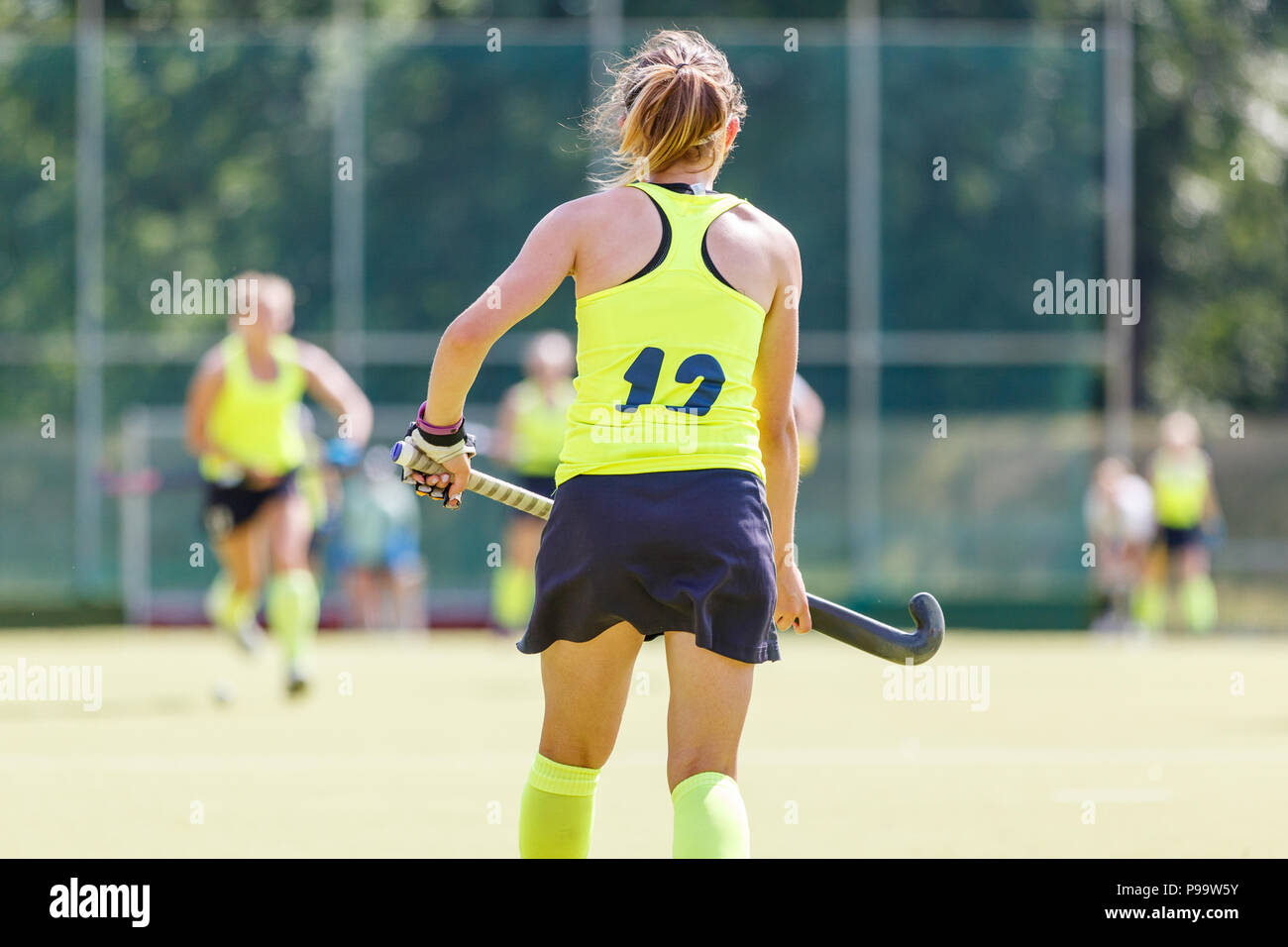 Young hockey player girl with stick in the game Stock Photo - Alamy