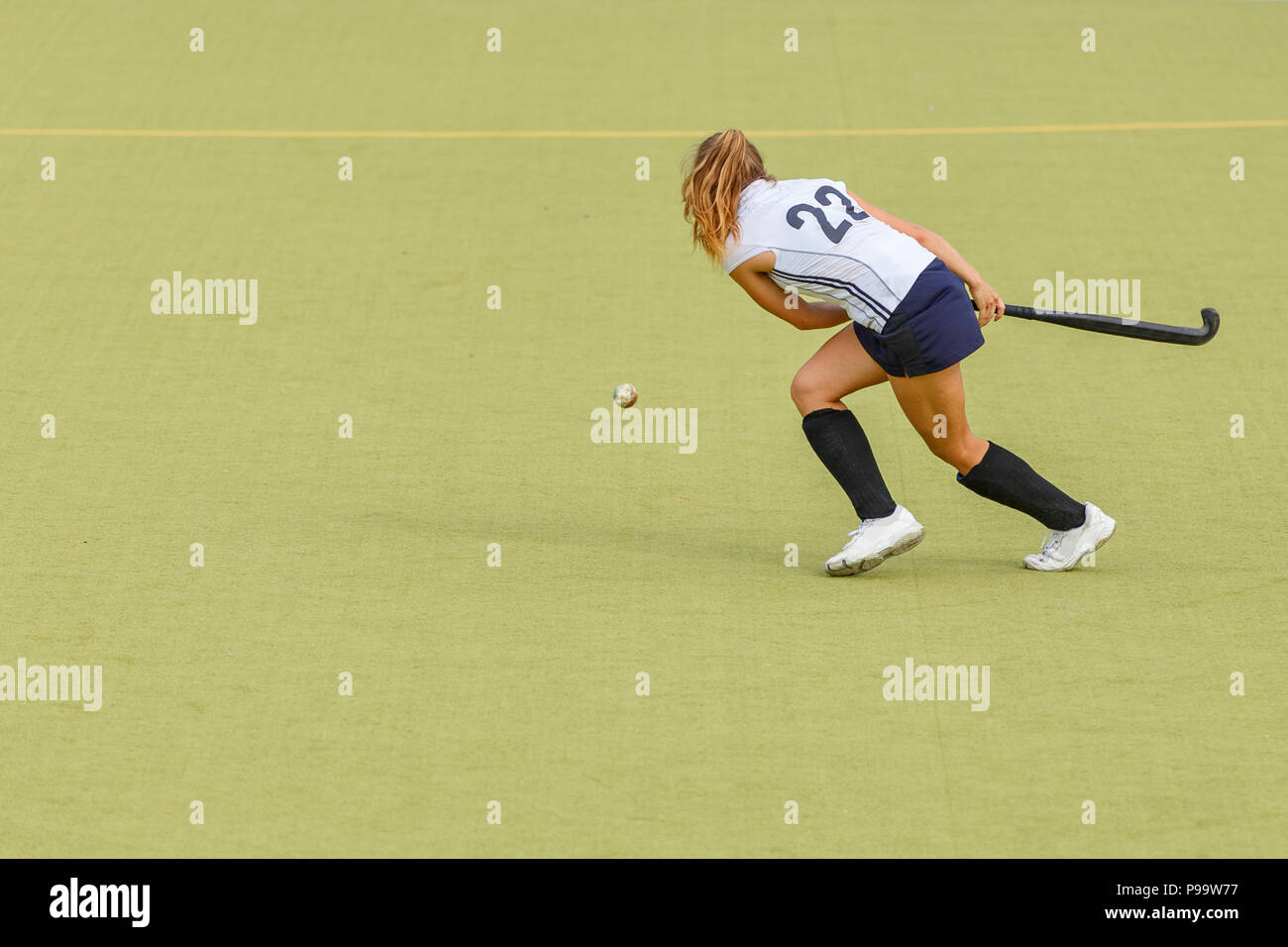 Young hockey player woman with ball in attack Stock Photo - Alamy