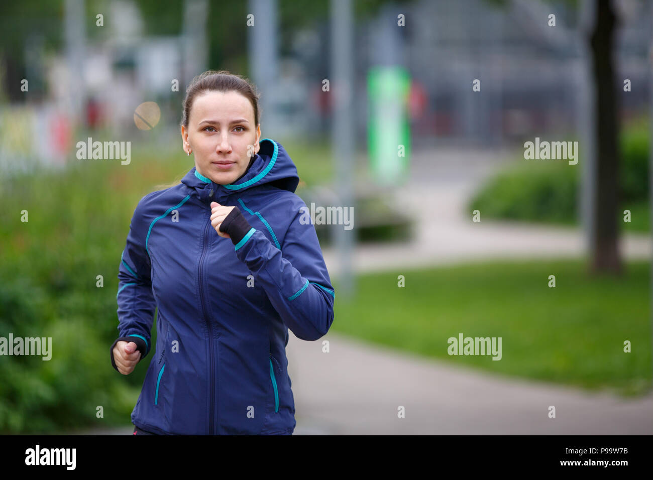 Athletic female in blue jacket hi-res stock photography and images - Alamy