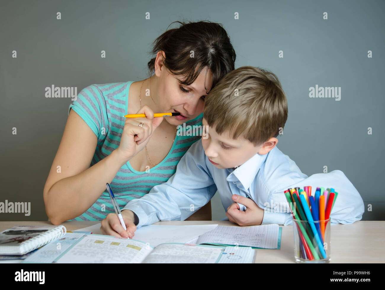 Mom and son do homework at home Stock Photo - Alamy