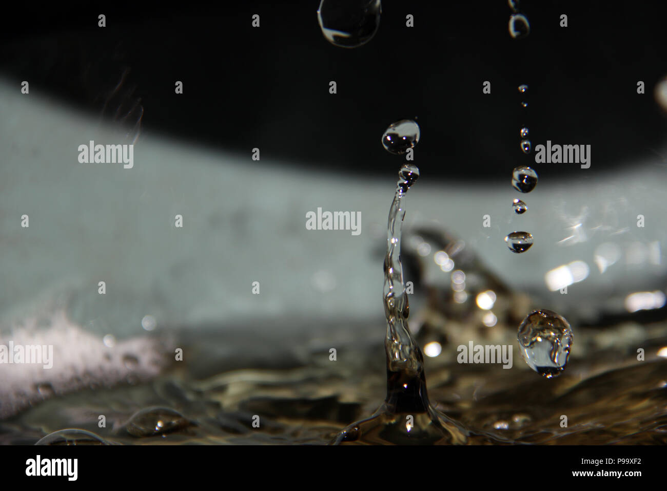 Droplets hitting water surface Stock Photo - Alamy