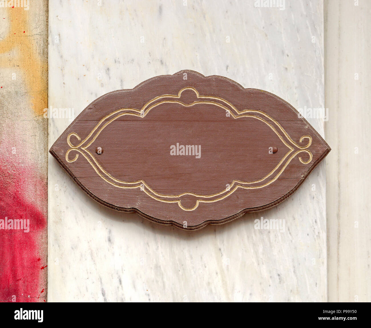 Wooden sign in interesting shape at wall Stock Photo - Alamy