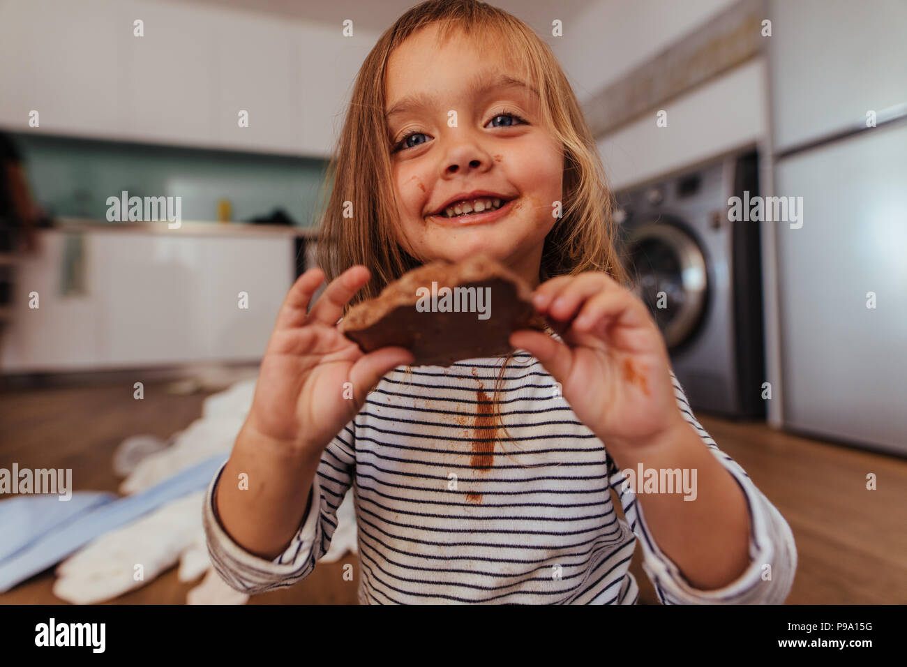 Beautiful girl child showing a chocolate she is eating. Little girl ...