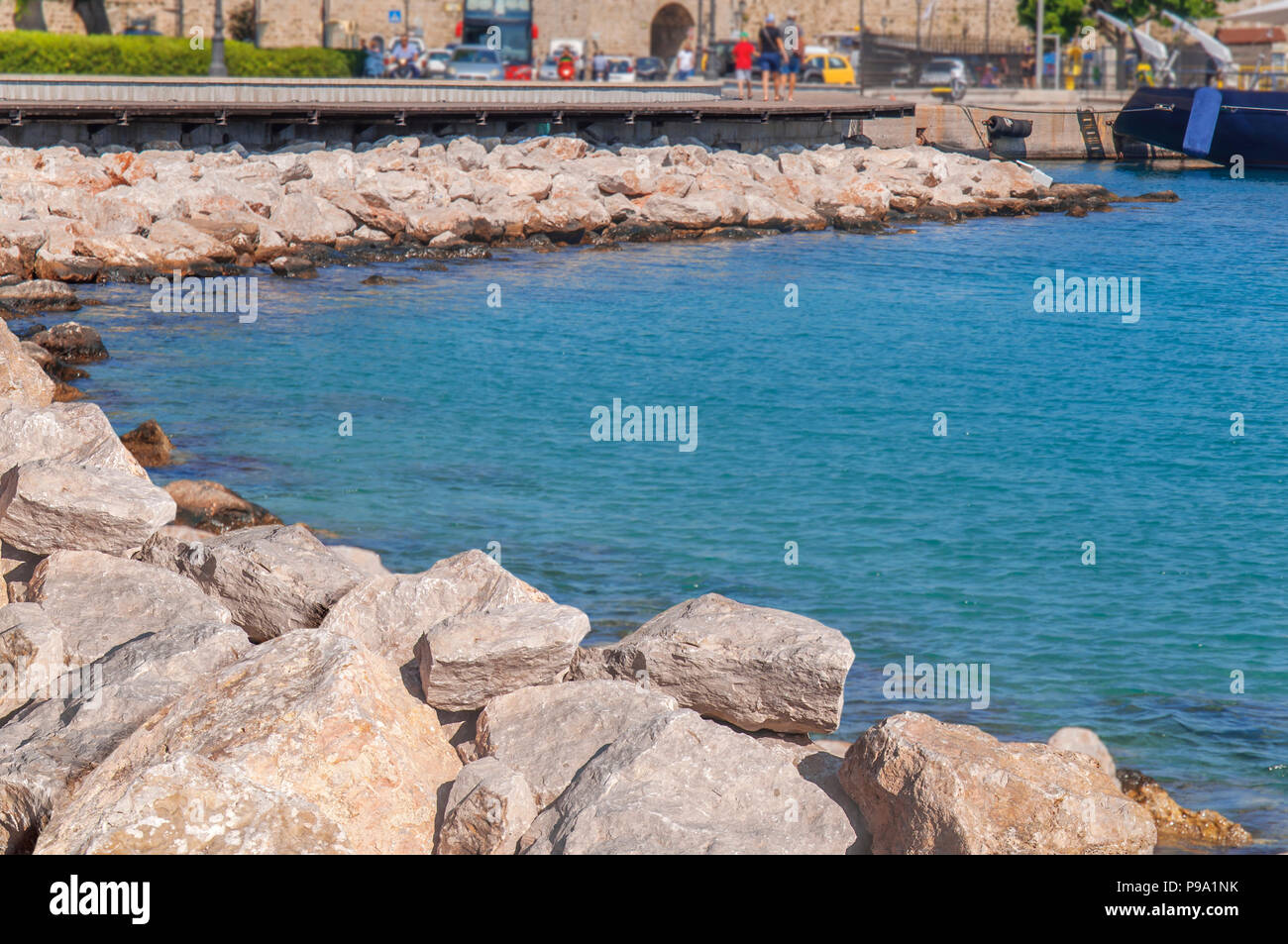 Part of wooden dock for wlking with big sea stone on Greek iceland ...