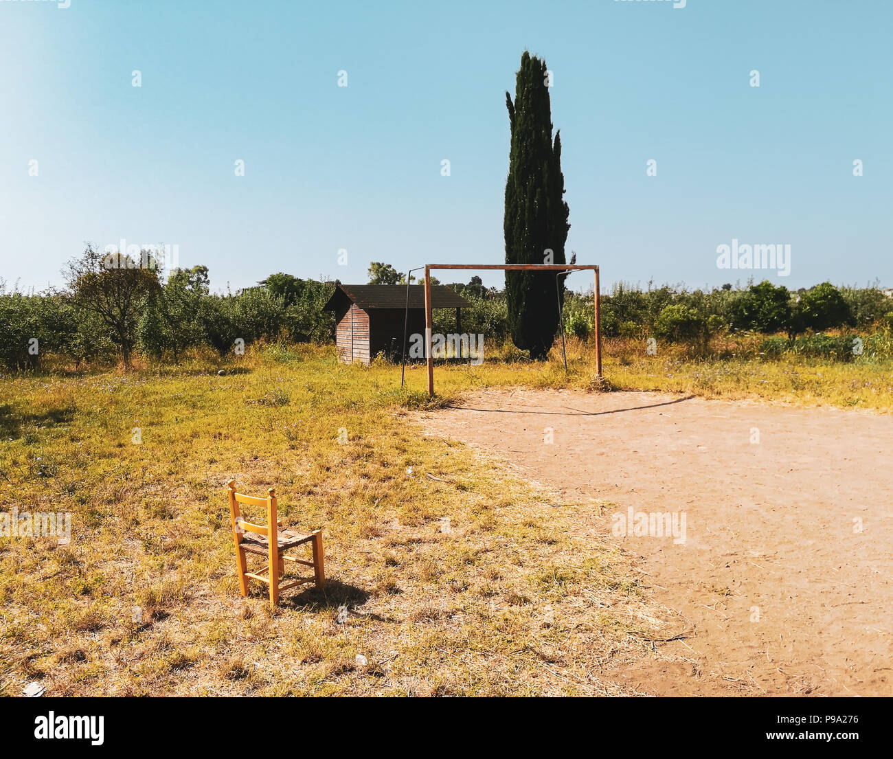 Empty humble football playing field with chair, italian countryside ...